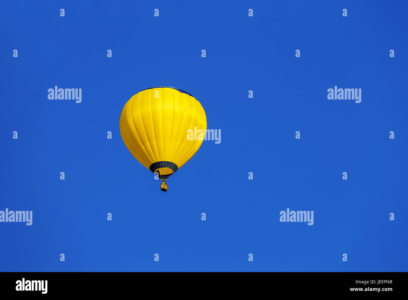 Yellow balloon in blue sky Stock Photo - Alamy