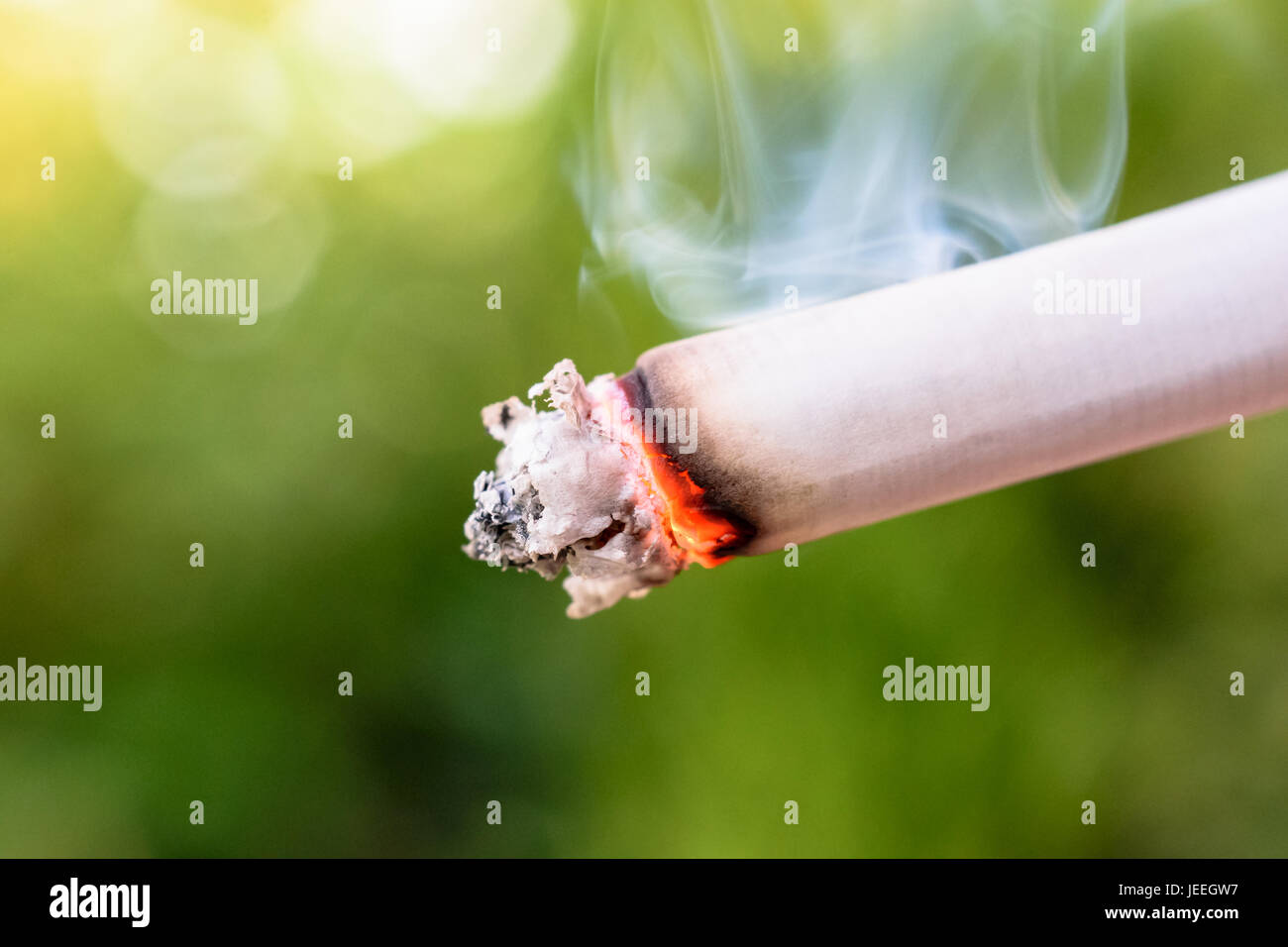 Smoking Cigarette (Orange Glow & Smoke Stock Photo - Alamy