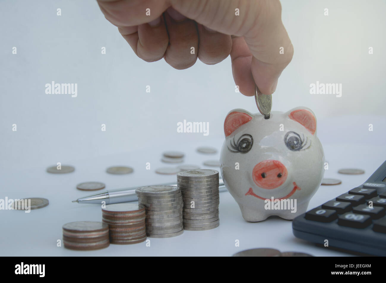 stack coin with hand drop the coin into piggy bank. Financial and ...