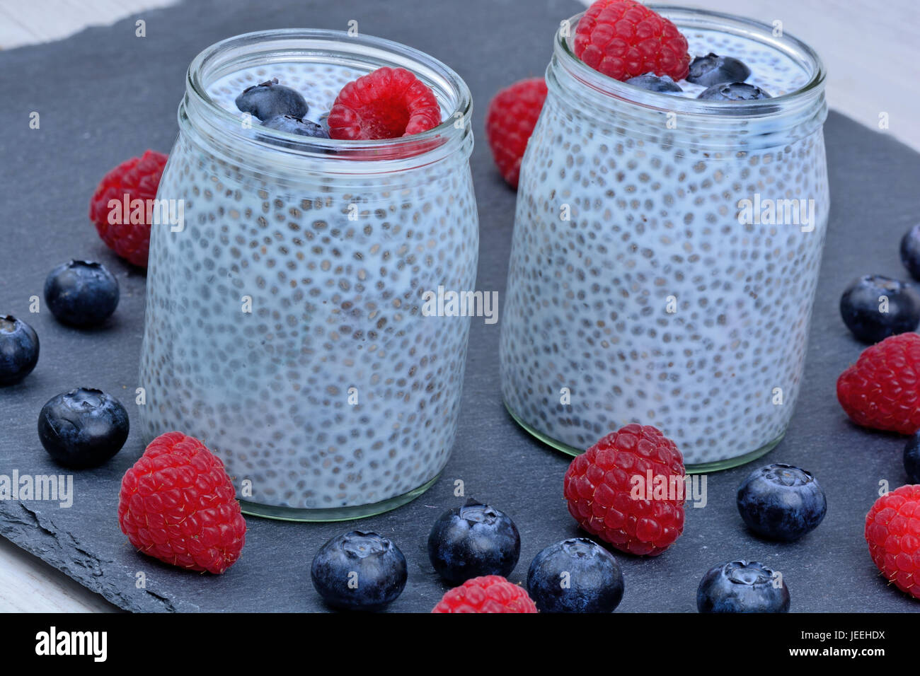 Chia seeds pudding with raspberry and blueberry on table Stock Photo ...