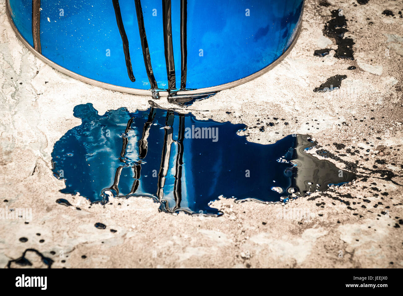 Construction paint is spilled from the barrel to the ground Stock Photo ...