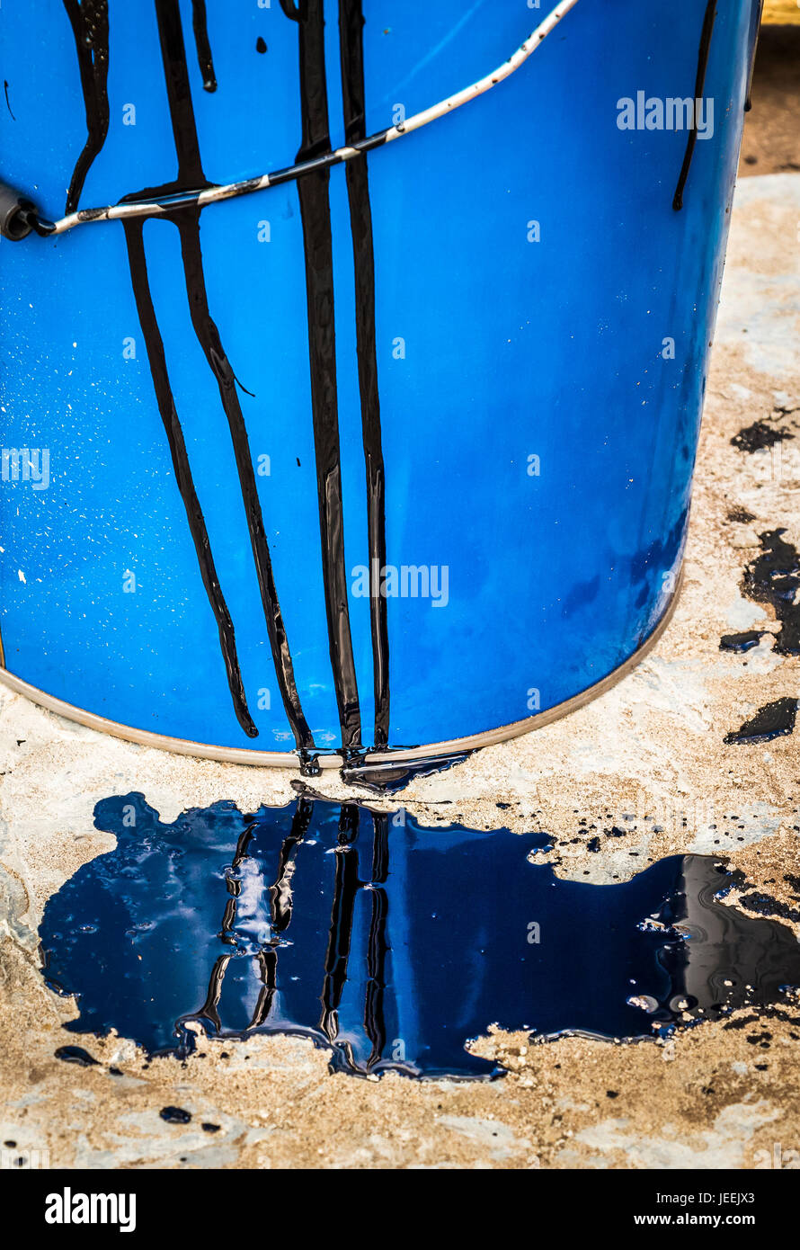 Construction paint is spilled from the barrel to the ground Stock Photo ...