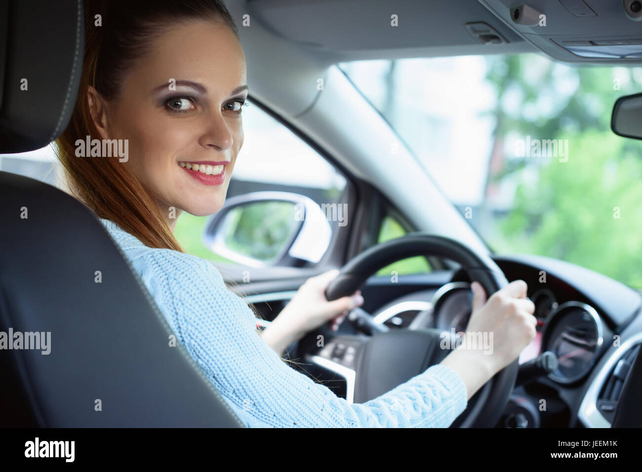 Rear view of a confident and beautiful young woman in casual wear ...