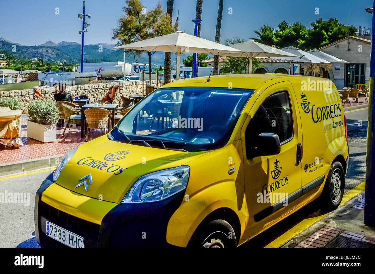 A yellow van carrying post in Mallorca Stock Photo - Alamy