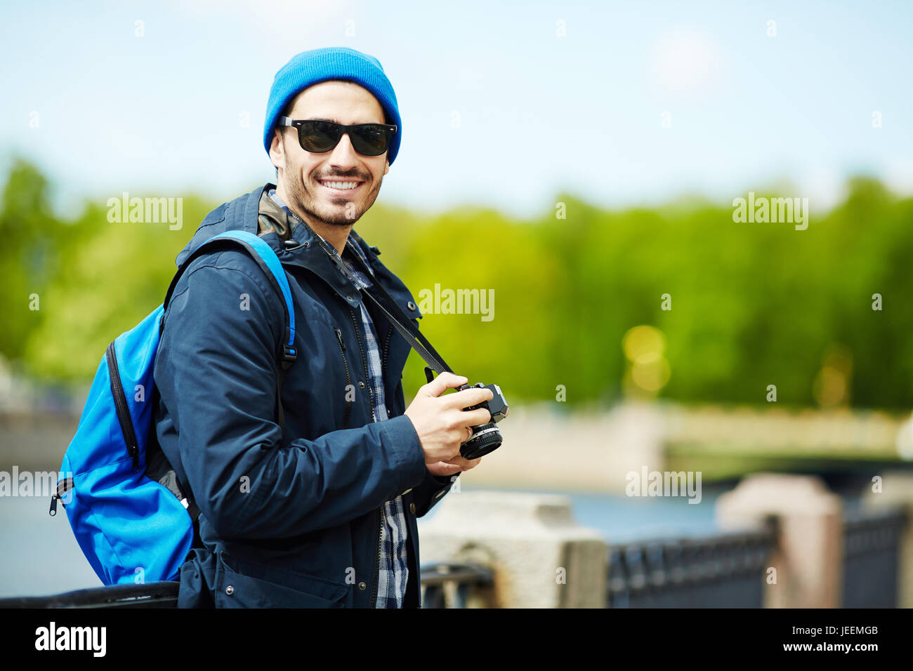 Young backpacker with rucksack and photocamera Stock Photo - Alamy