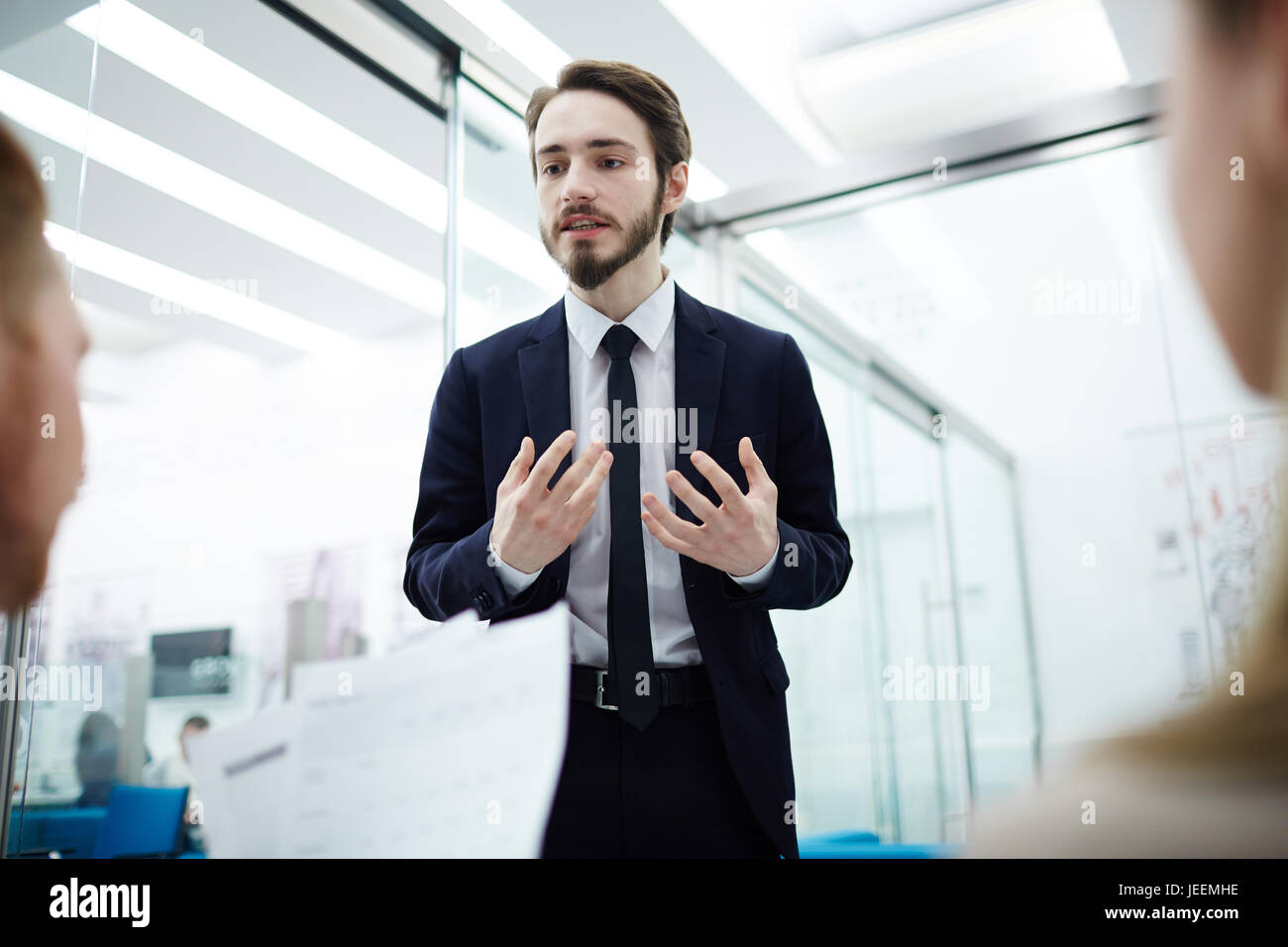 Businessman explaining his viewpoint to co-workers Stock Photo - Alamy