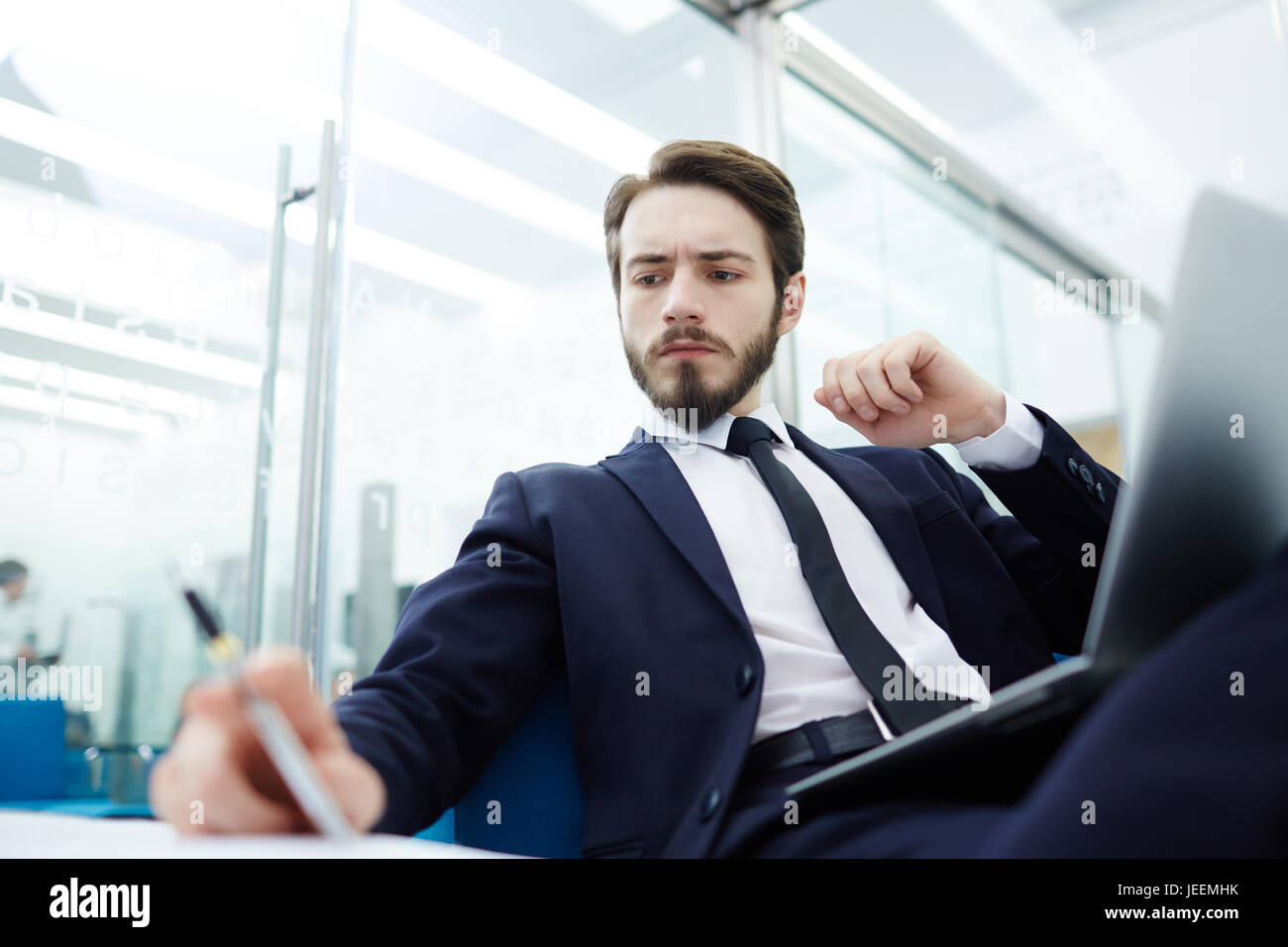 Busy salesman reading financial papers Stock Photo - Alamy