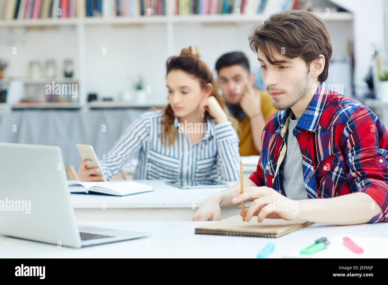 Serious student reading online data or carrying out test at lesson ...