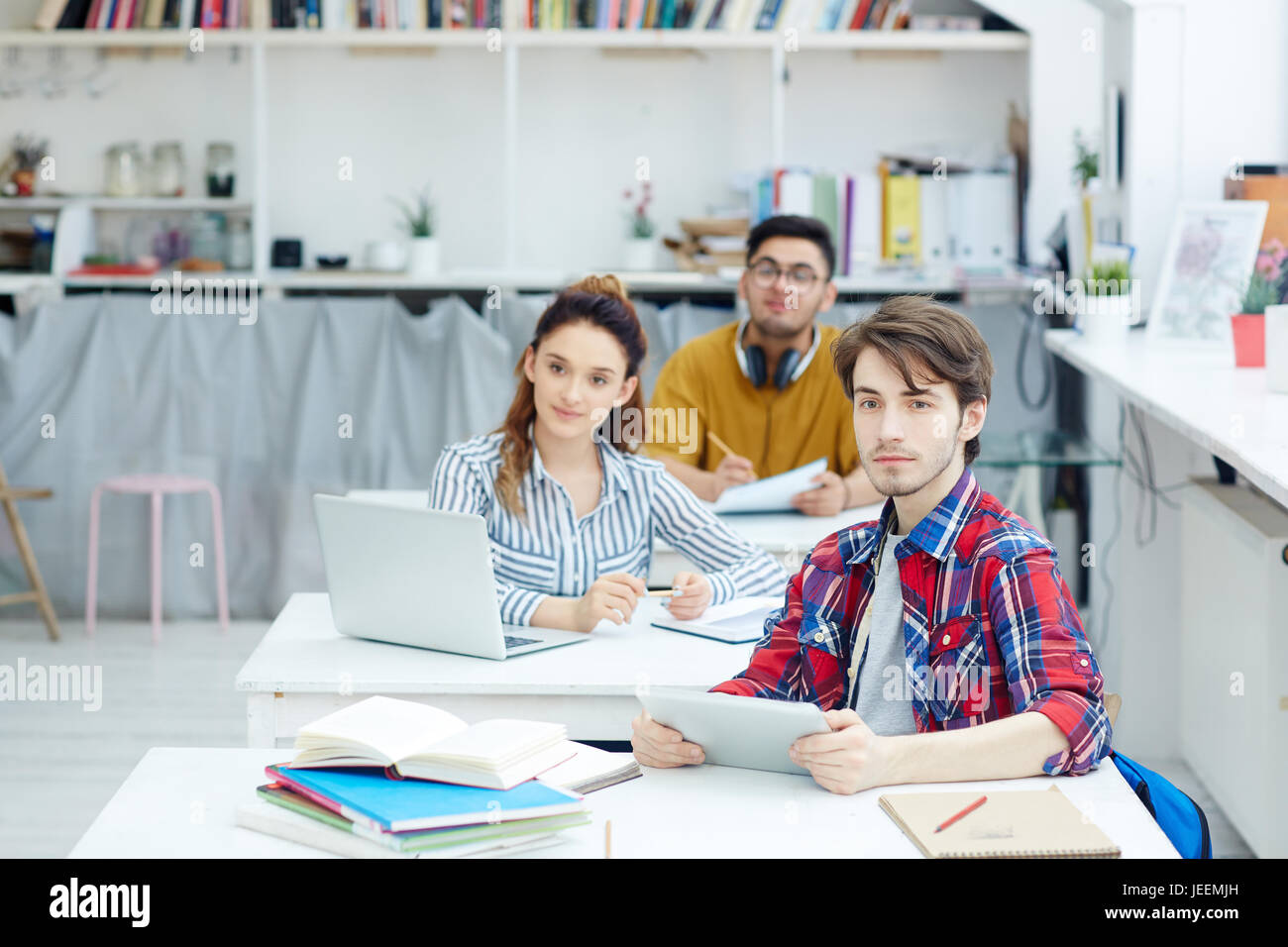 Students with gadgets listening to teacher at lesson Stock Photo - Alamy