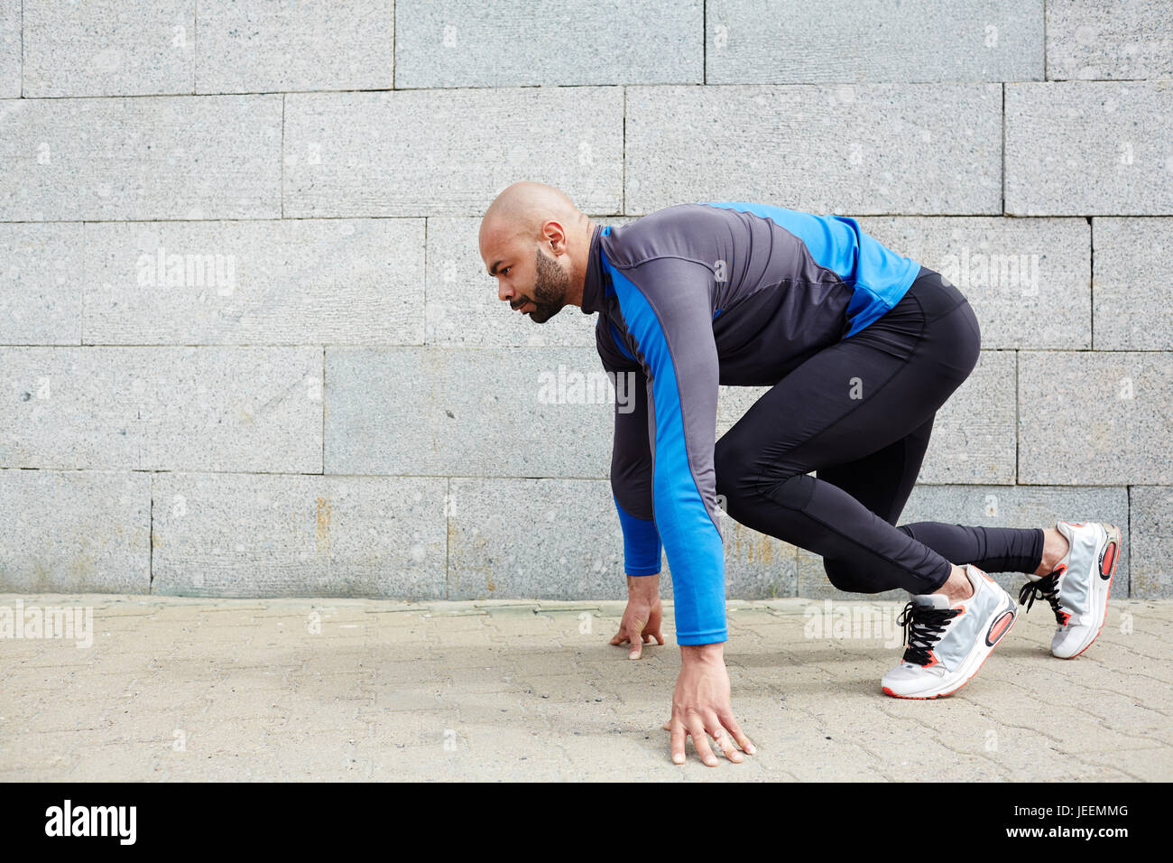 Man stretching against wall hi-res stock photography and images - Alamy