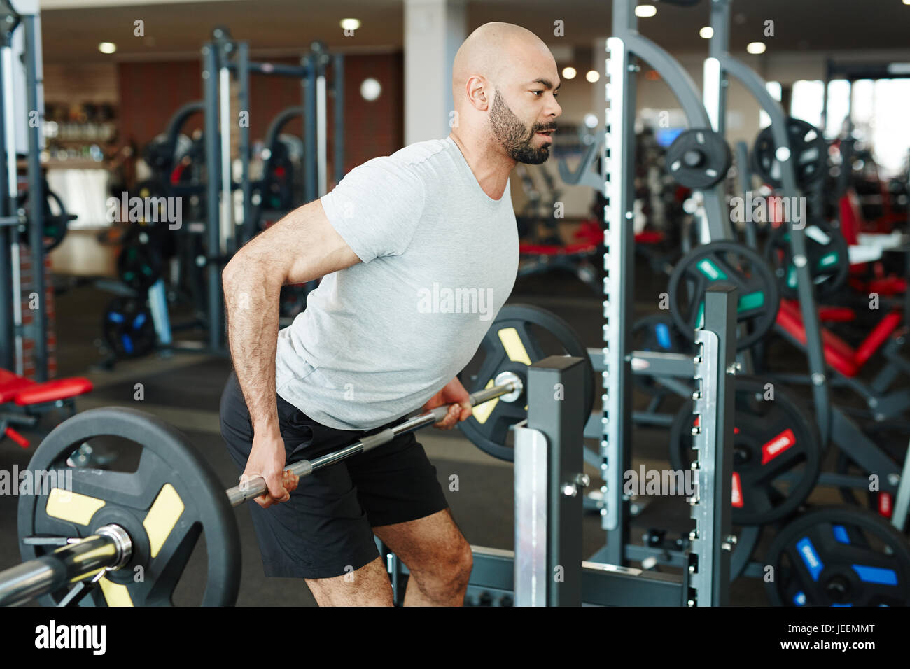 Strong man lifting weight in gym Stock Photo - Alamy