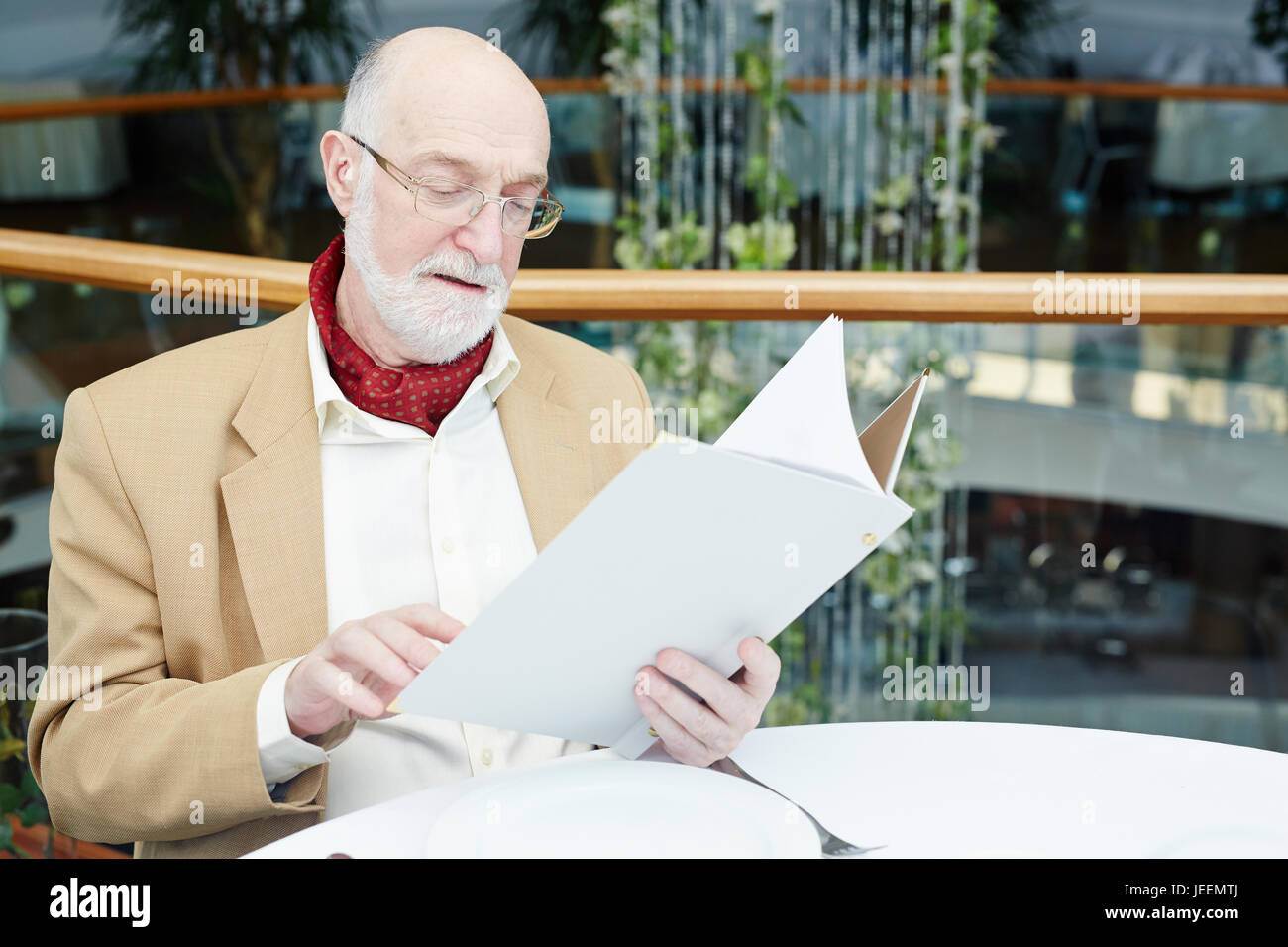 Elderly man reading menu hi-res stock photography and images - Alamy