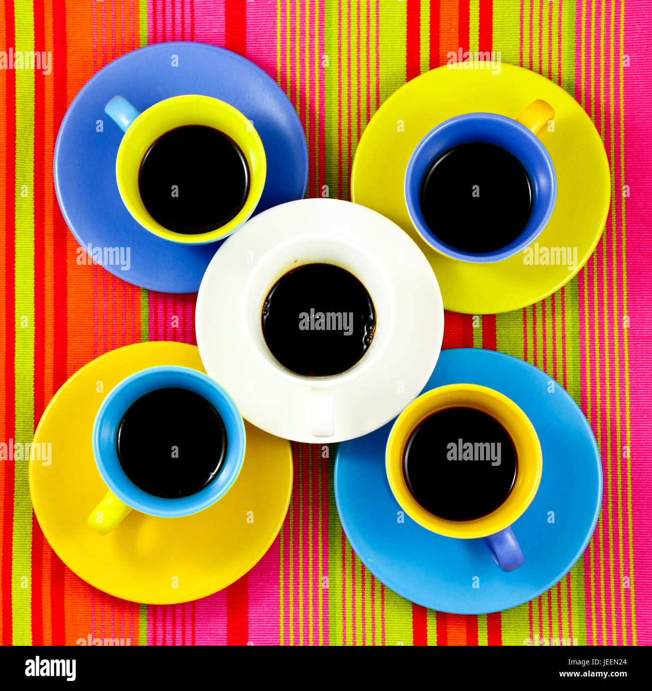 flat lay coffee four color bright cups with different bright plates ...