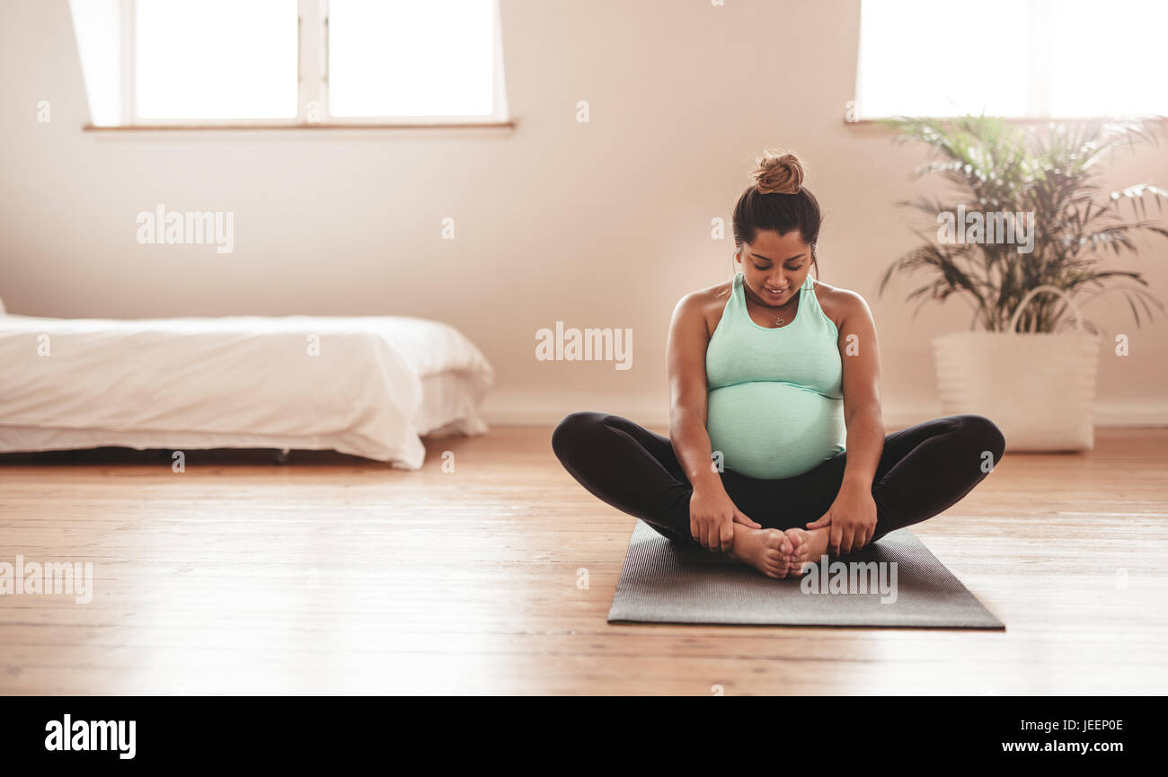 Portrait Of Young Pregnant Female Working Out At Home African Pregnant
