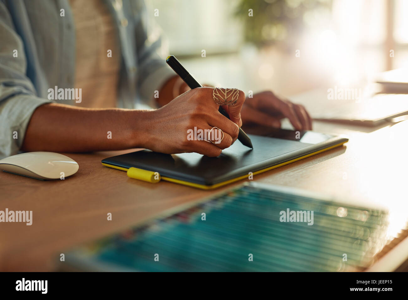 Closeup of woman's hand using a graphic tablet and stylus pen. Female ...