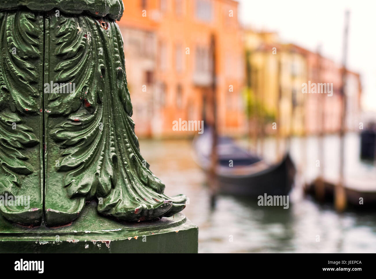 Detail view of cast iron lamp post with gondolas and the Grand Canal ...