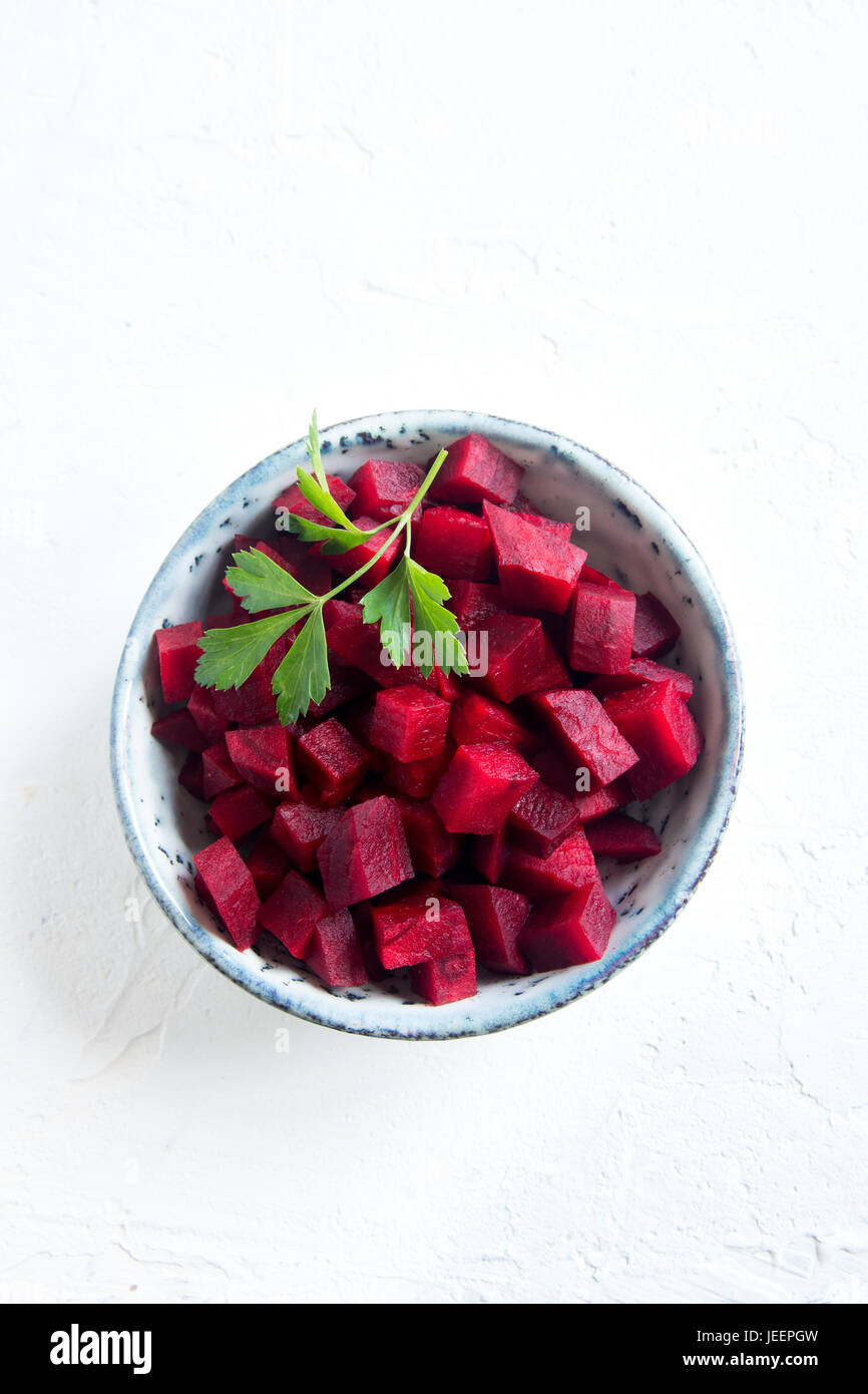 Beetroot (beet) chopped for salad in bowl over white background with ...