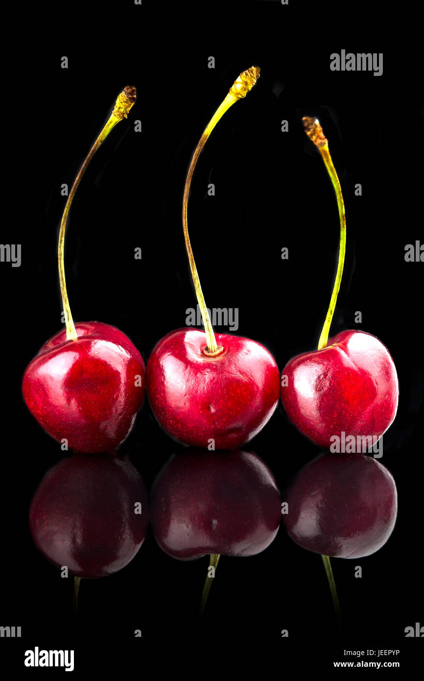 Cherry with reflection on a black background Stock Photo - Alamy
