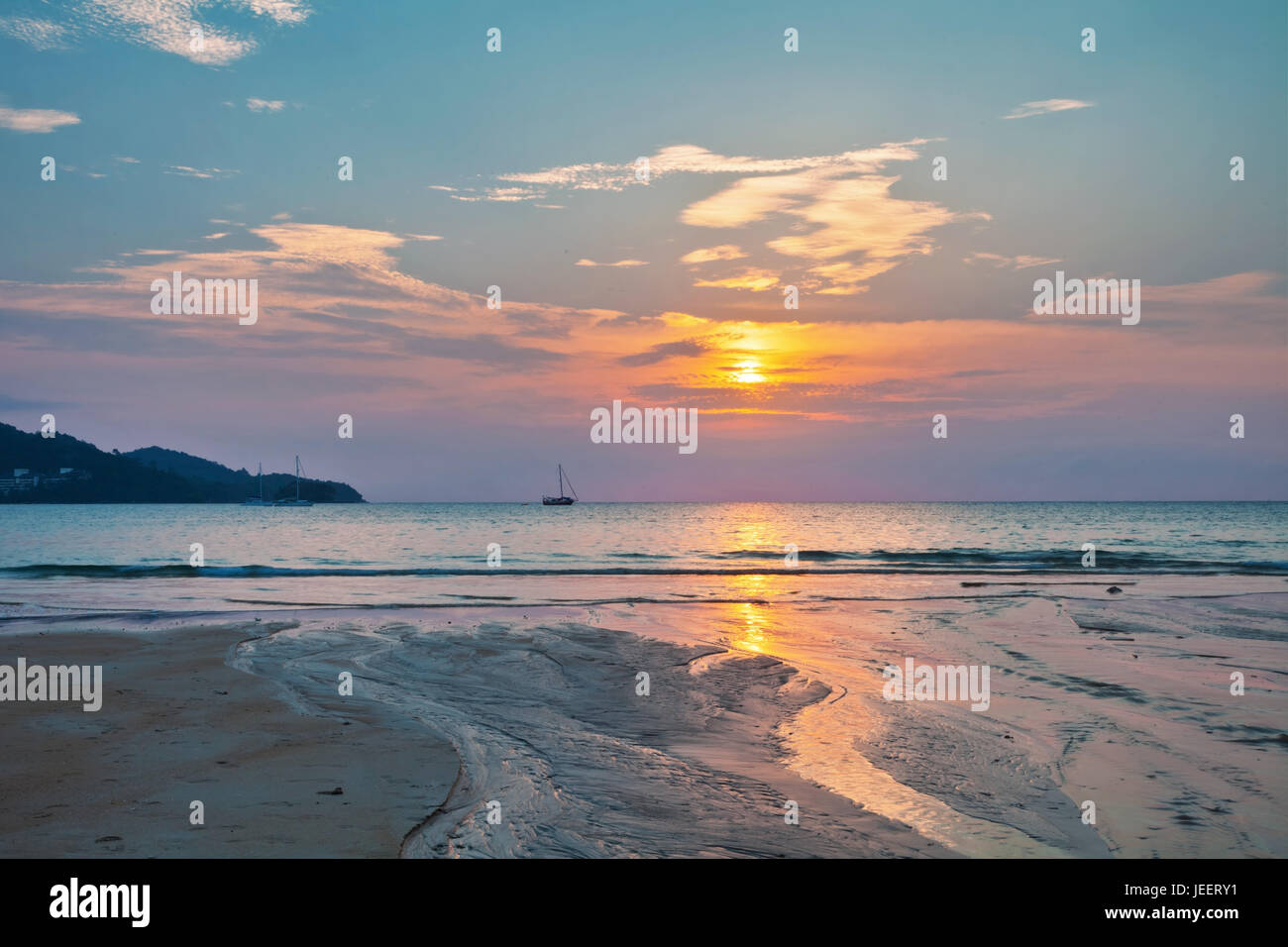 Tropical beach in ebb time on sunset background Stock Photo - Alamy