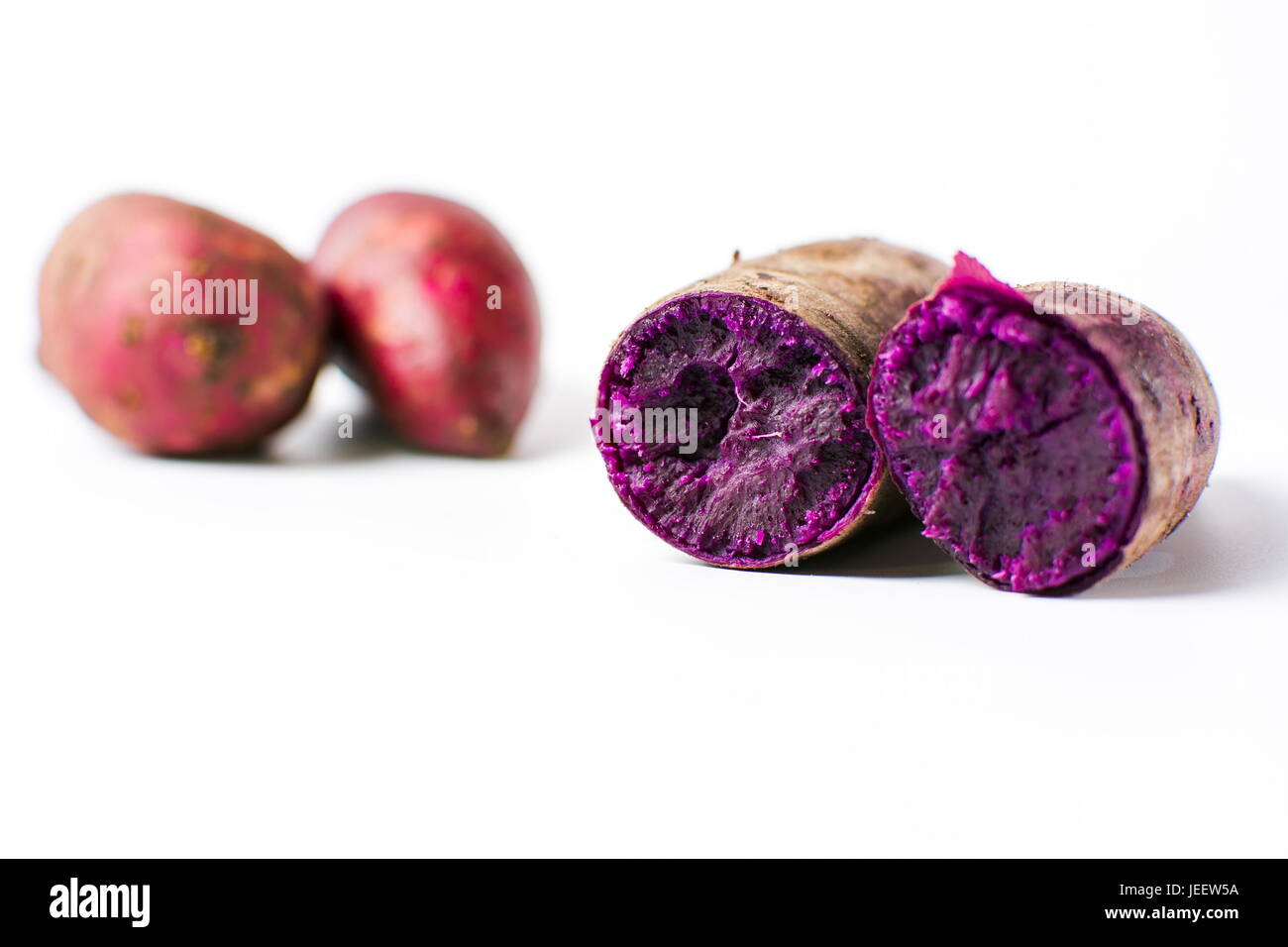 Cooked purple potato isolated on white background Stock Photo - Alamy