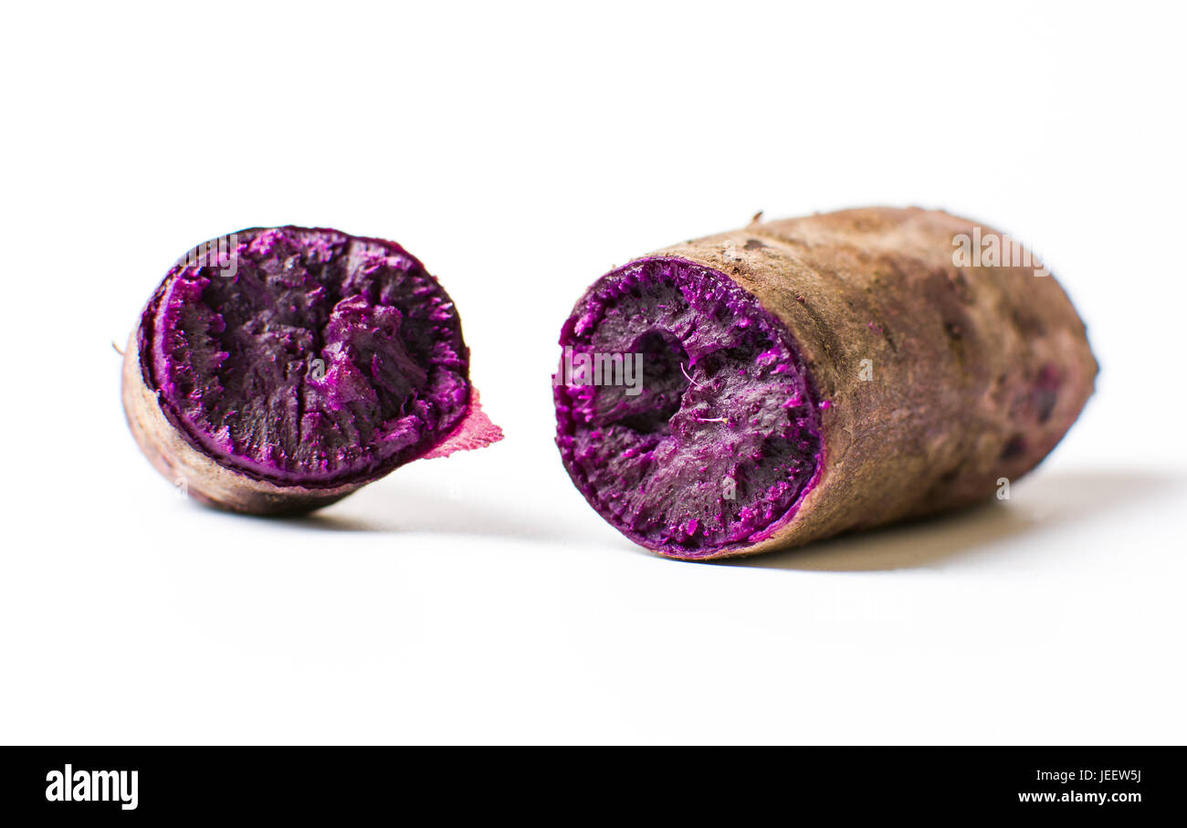 Cooked purple potato isolated on white background Stock Photo - Alamy