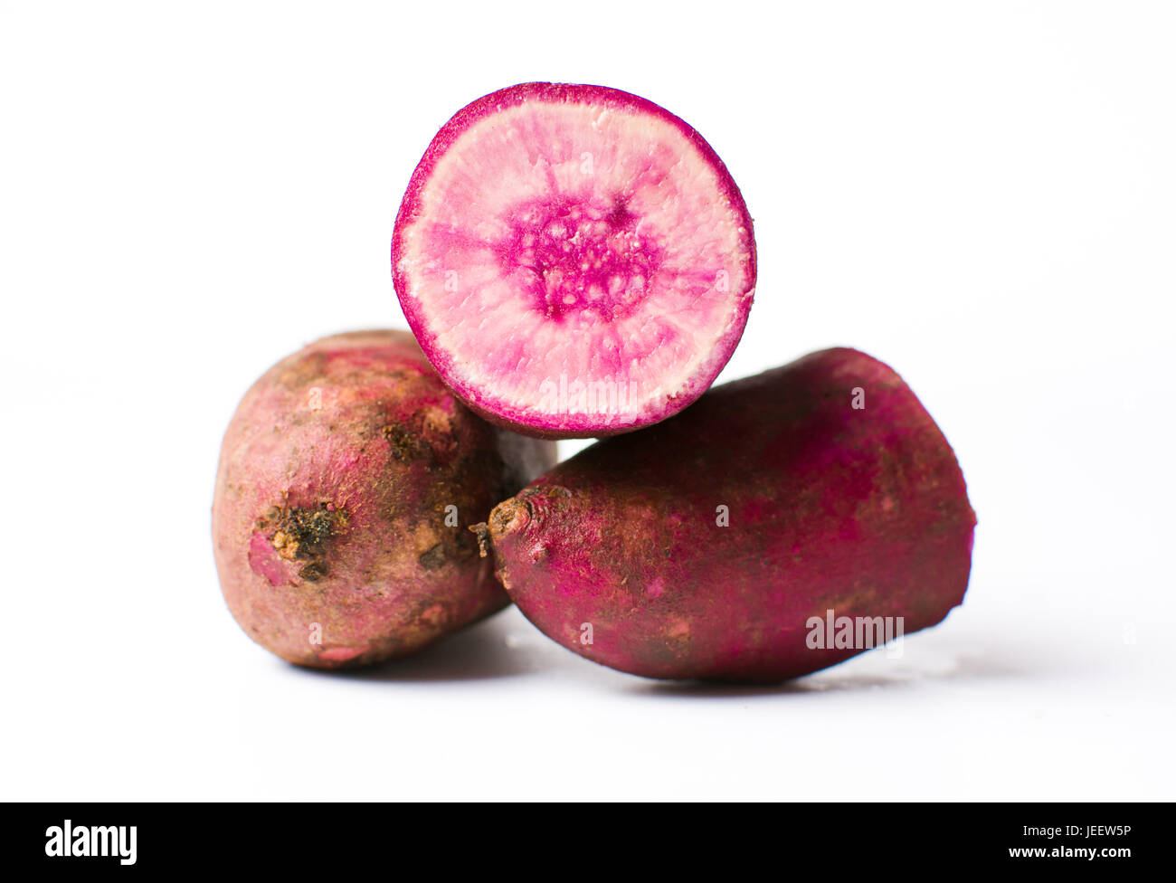 Raw purple potato isolated on white background Stock Photo - Alamy
