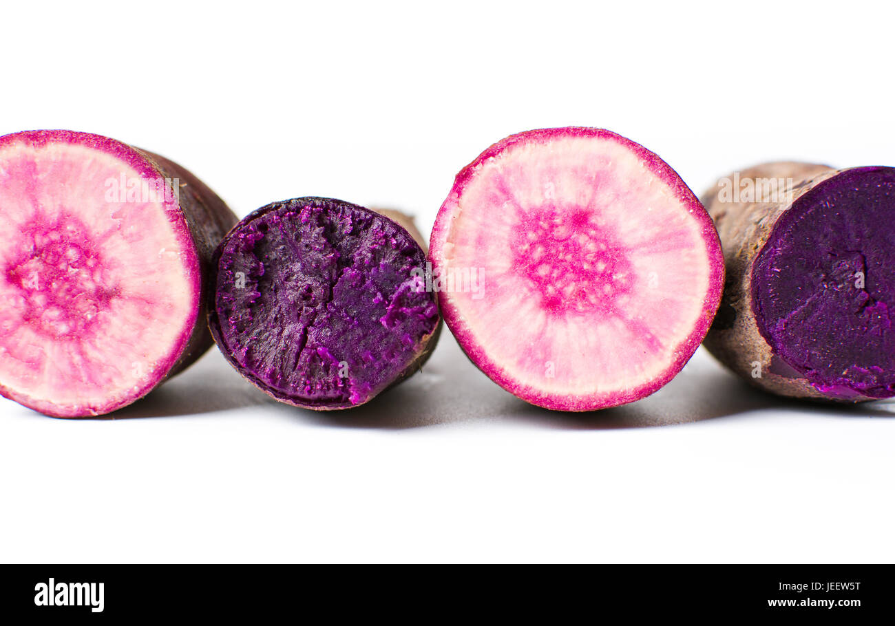 Raw and cooked purple potatoes isolated on white Stock Photo - Alamy