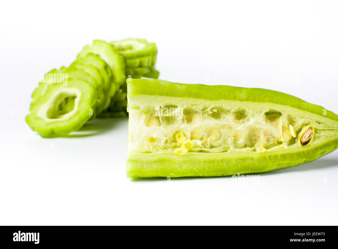 Sliced bitter melon gourd on white background Stock Photo - Alamy