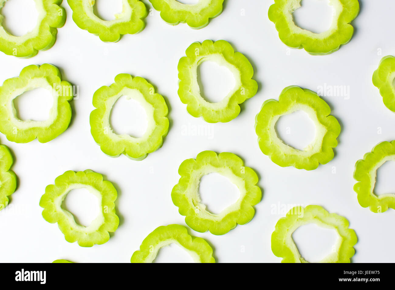 Sliced bitter melon gourd rings on white background Stock Photo - Alamy