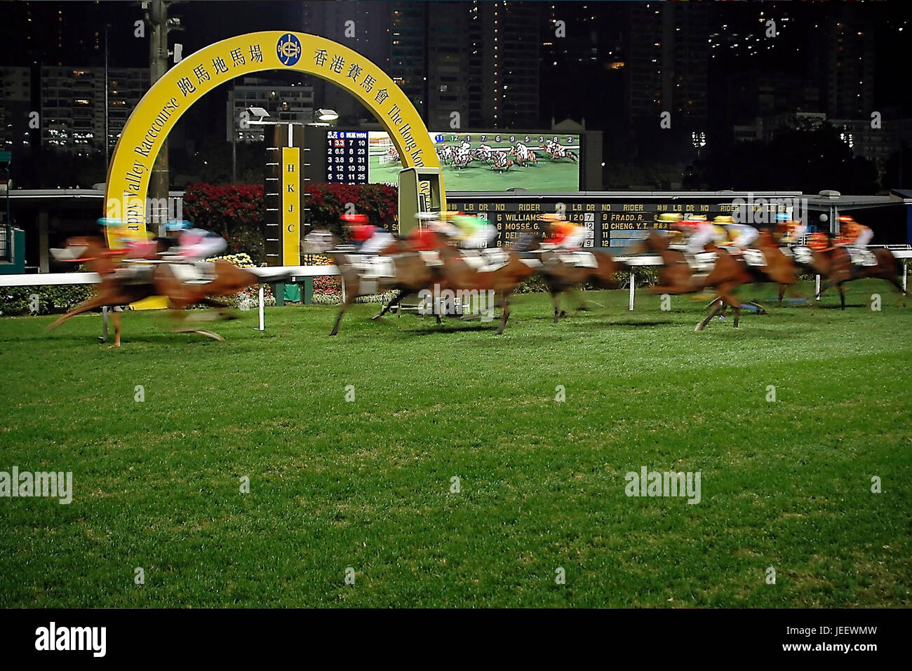 Horizontal view of racehorses crossing the winning post at the Happy ...