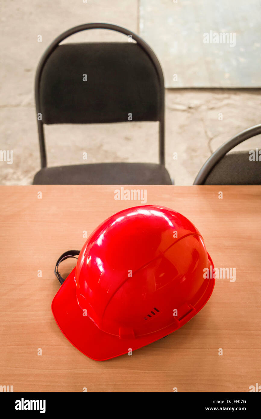 Production Red hard hat lying on the table during a break Stock Photo ...
