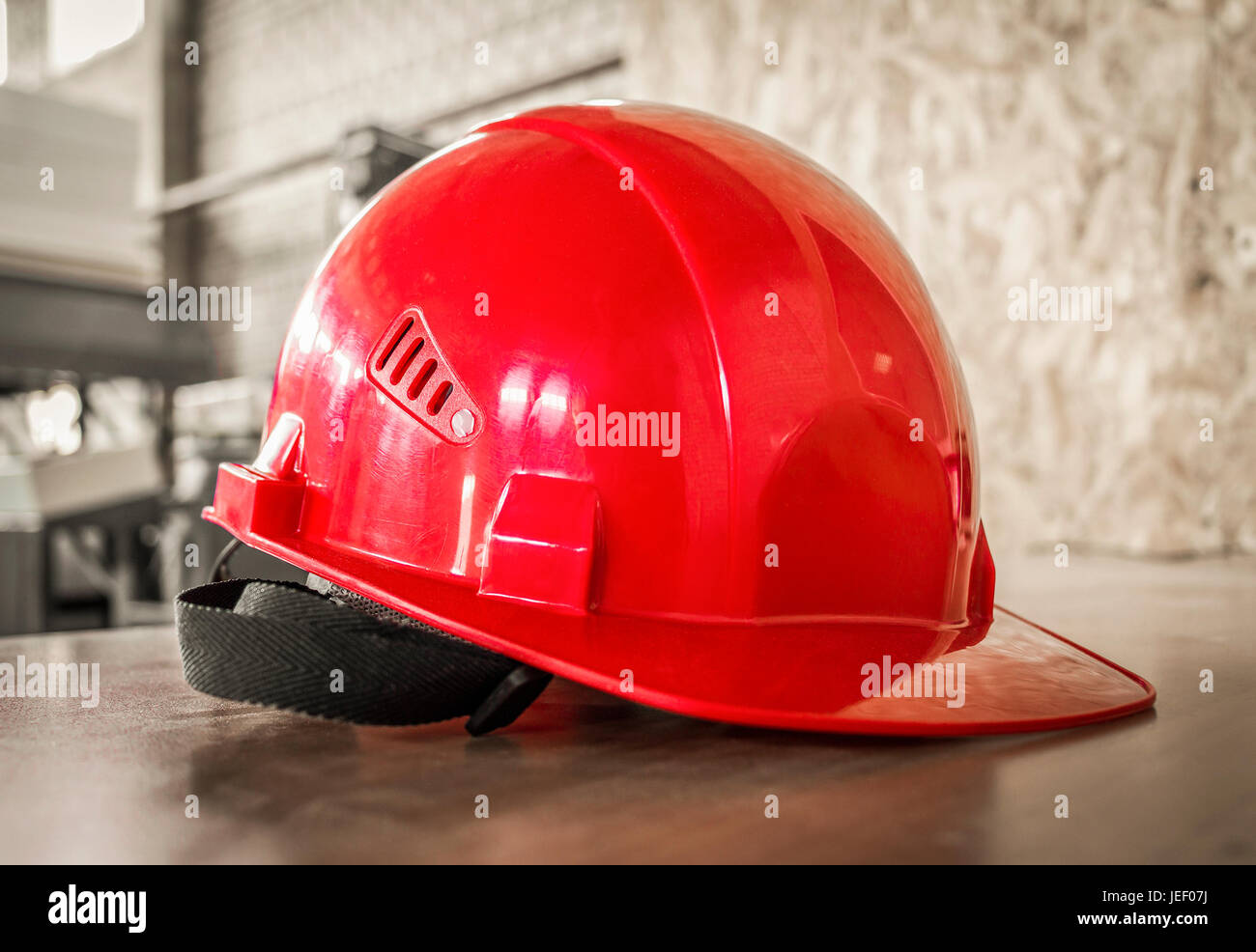 Production Red hard hat lying on the table during a break Stock Photo ...
