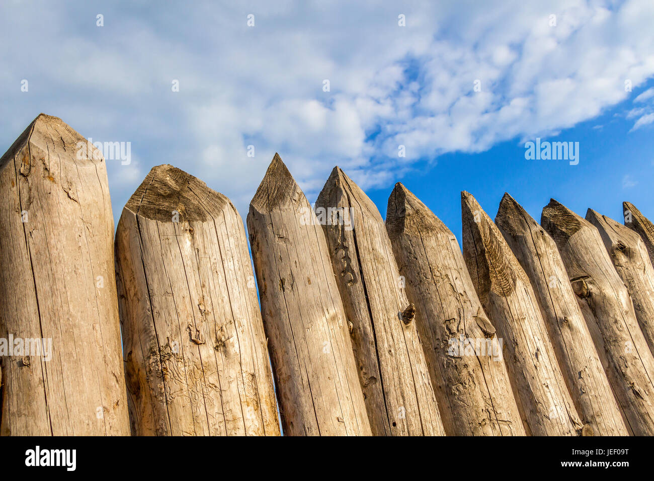 Protective fence of sharp wooden stakes closeup Stock Photo - Alamy
