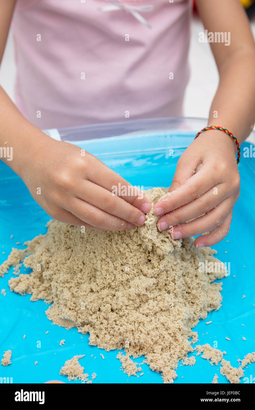 Child's hand close up playing sand at home indoors Stock Photo - Alamy