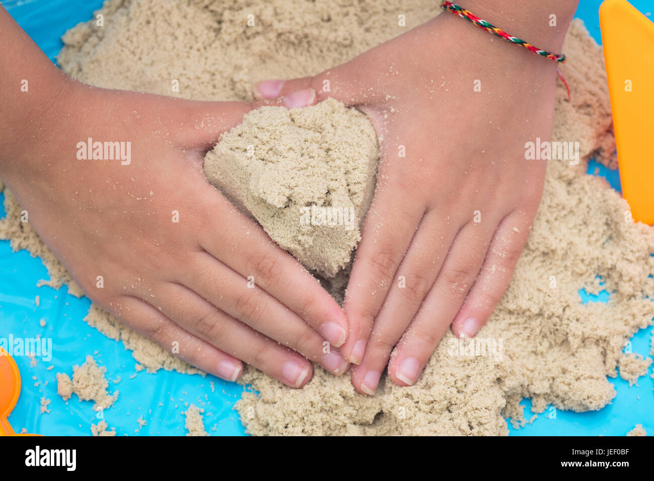 Child's hand close up playing sand at home indoors Stock Photo - Alamy