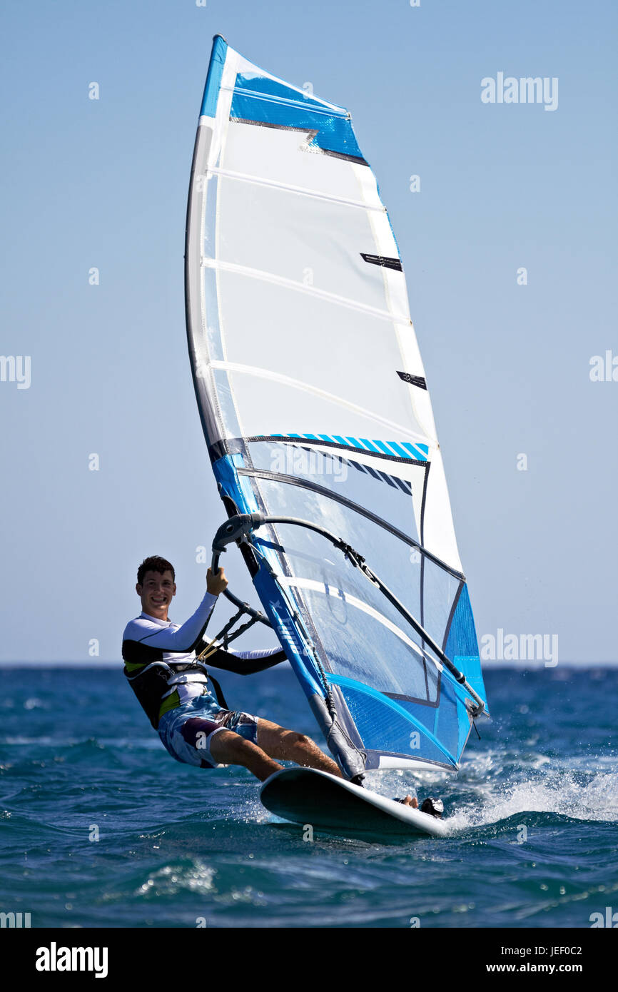 Front view of a windsurfer passing by Stock Photo - Alamy