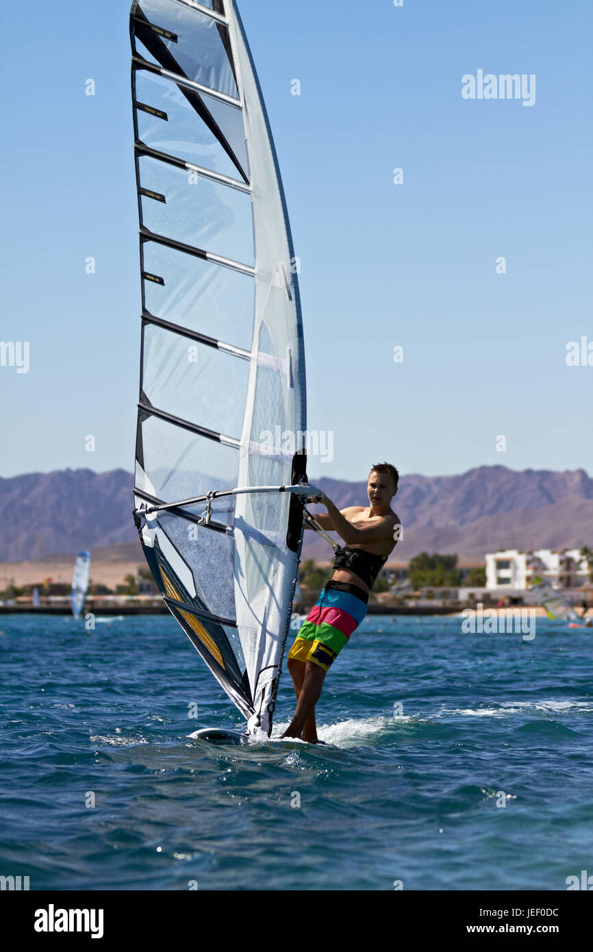 Front view of a windsurfer passing by Stock Photo - Alamy