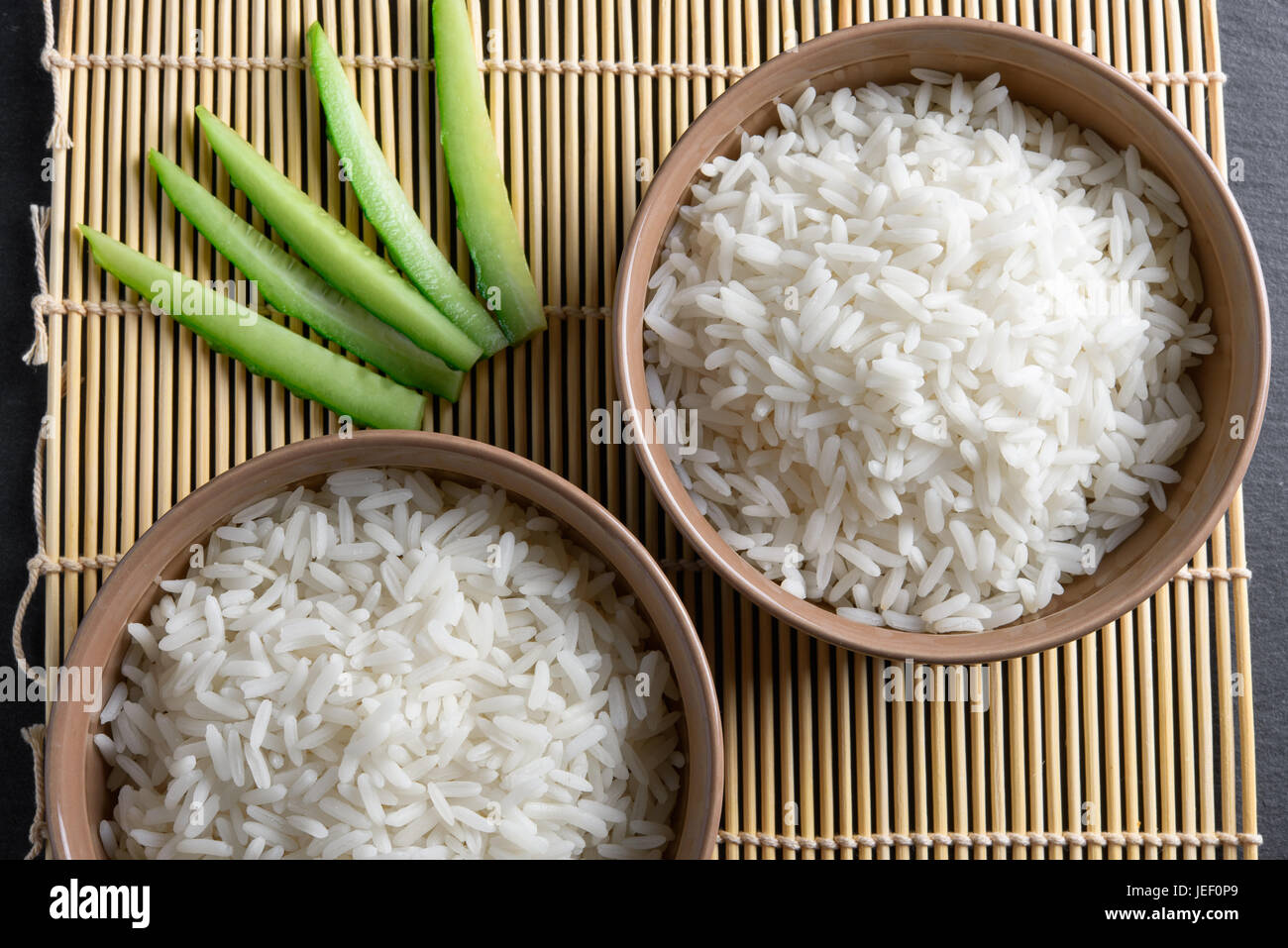 Top view: steamed cooked white basmati rice in round ceramic bowls over ...