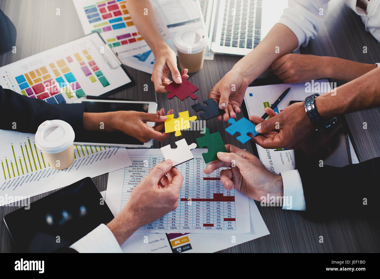 Teamwork of partners. Concept of integration and startup with puzzle ...