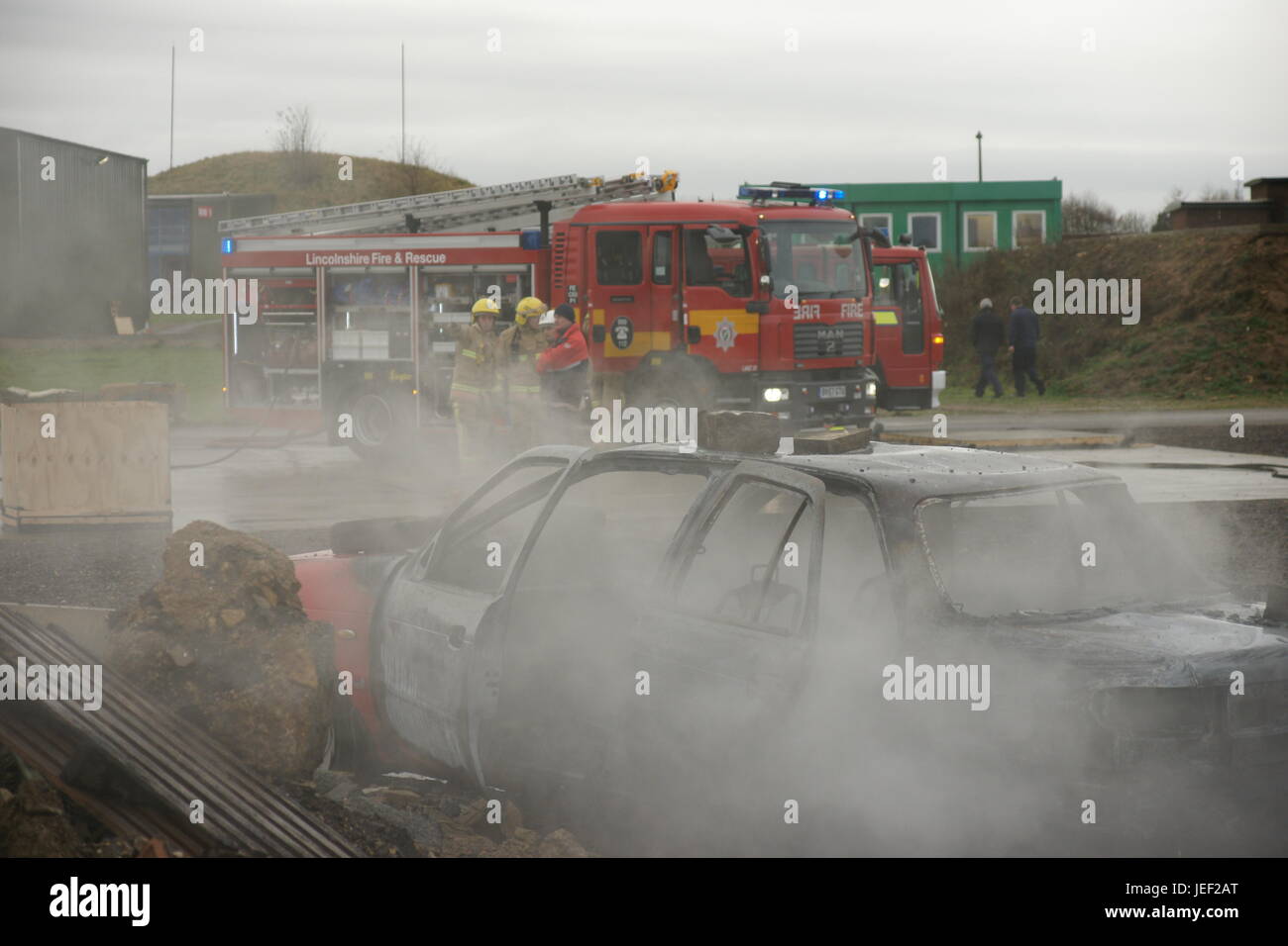 fire fighter fighting car fire Stock Photo - Alamy