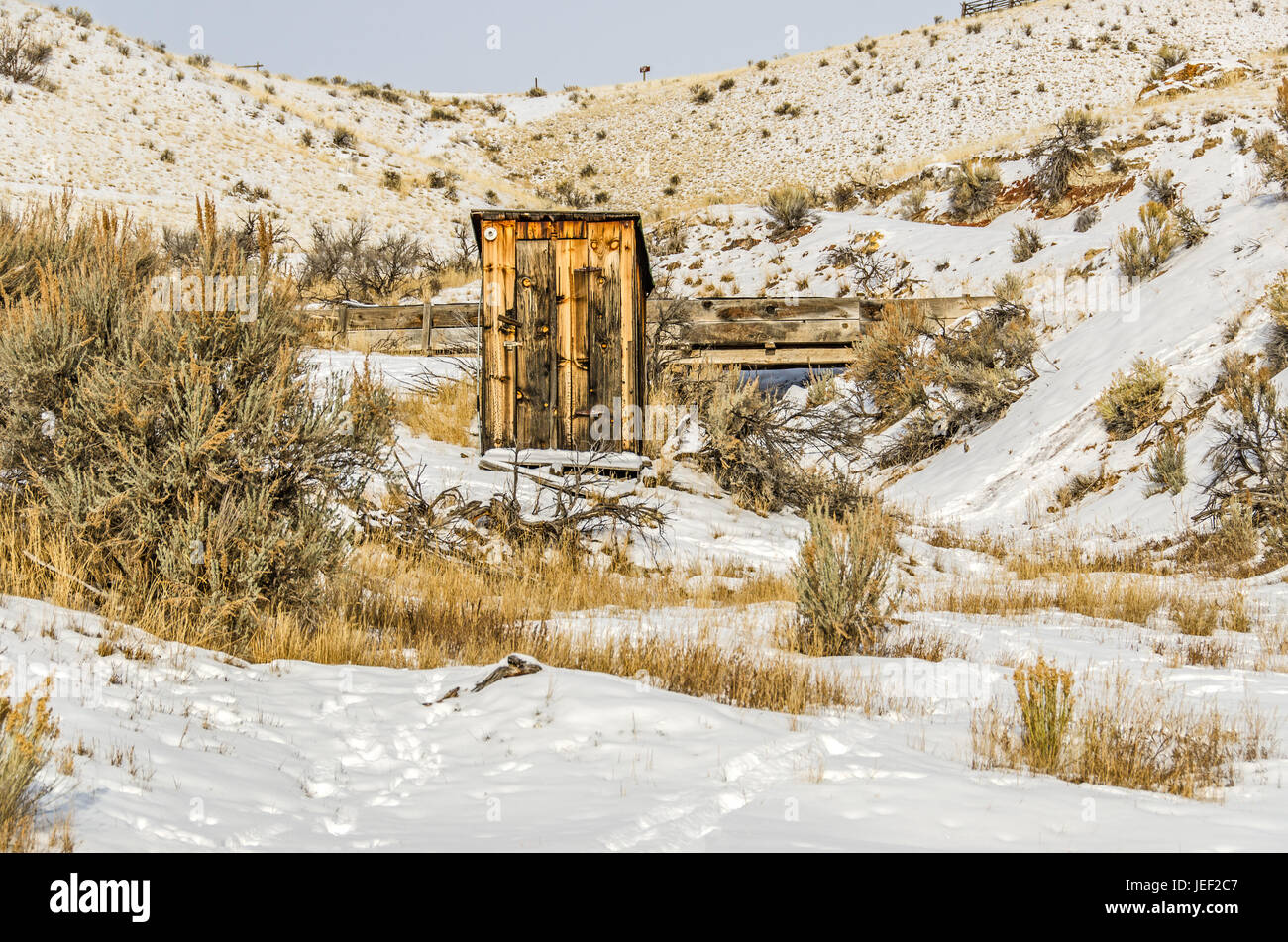 Sunlight on an old outhouse makes it glow on a winter day Stock Photo ...