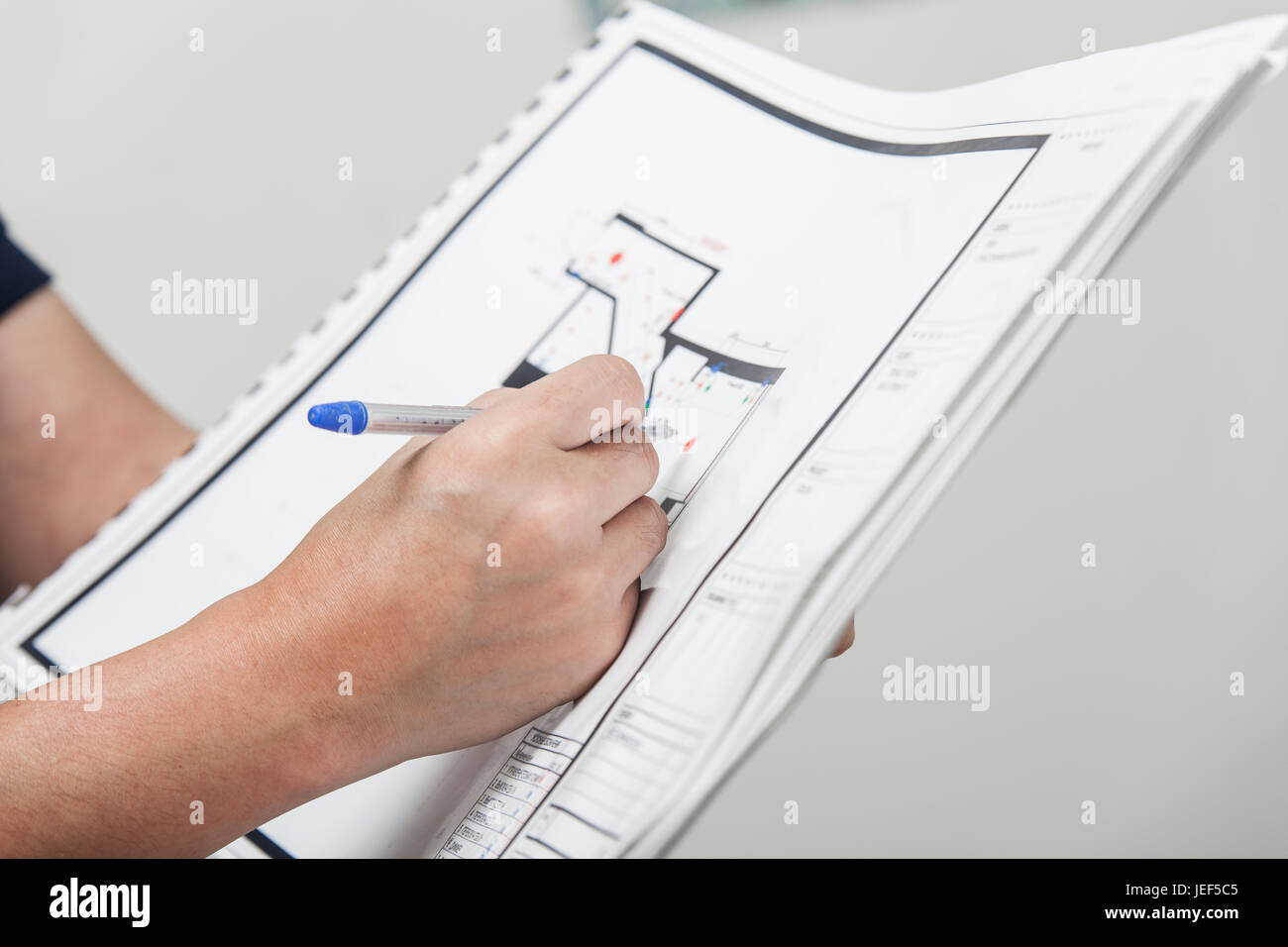 The architect studies the drawing of the new apartment Stock Photo - Alamy