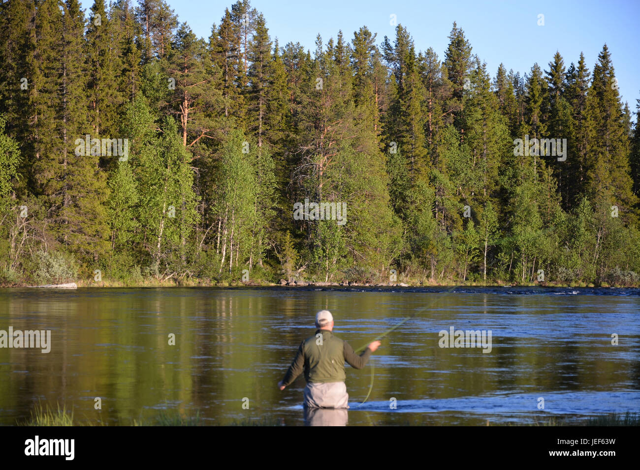 Angler with the aviation fishing in a river in the evening., Angler ...