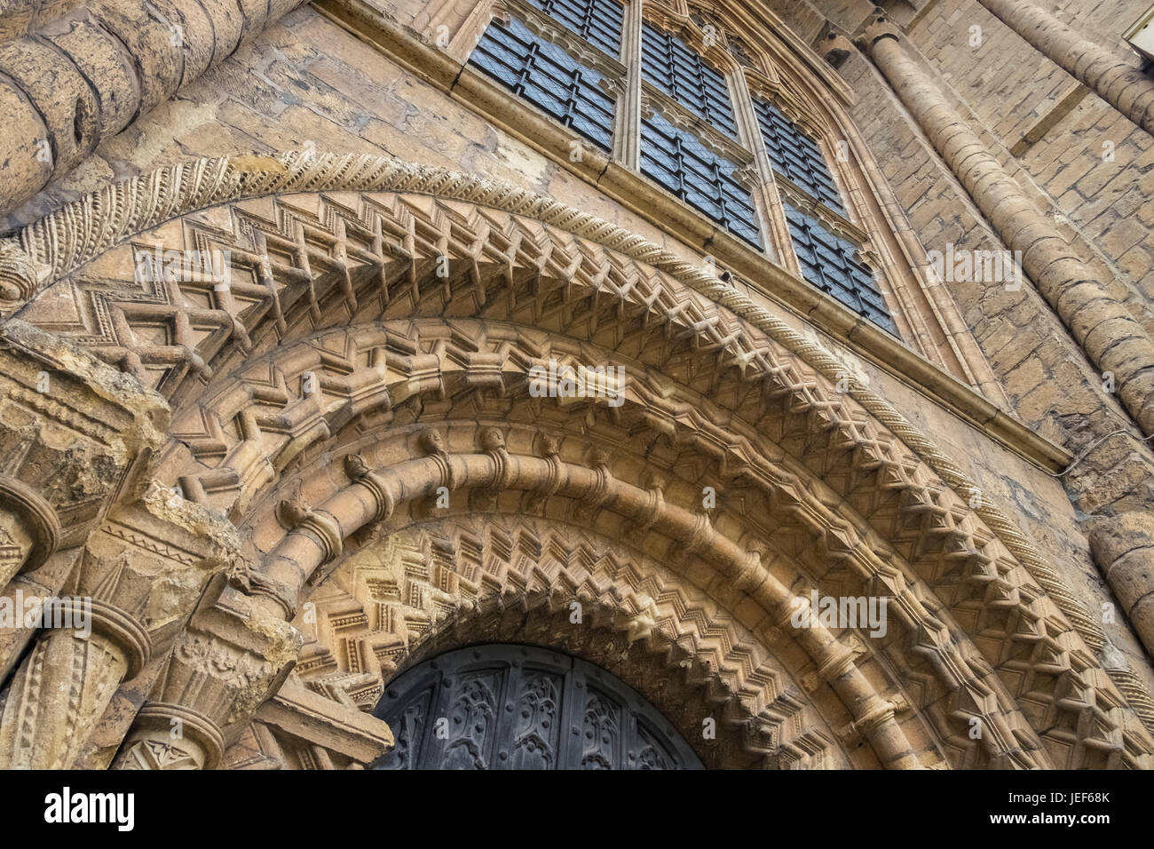 Clkose up detail of ornate arched stonework above west entrance to ...