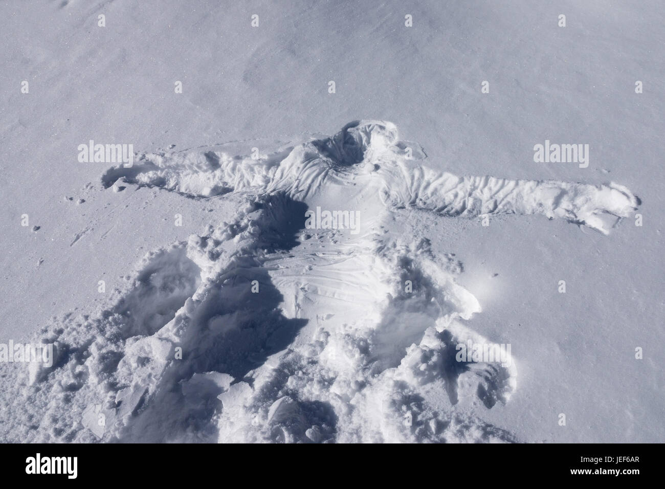 Person has left an impression of his body in the snow., Person hat im ...