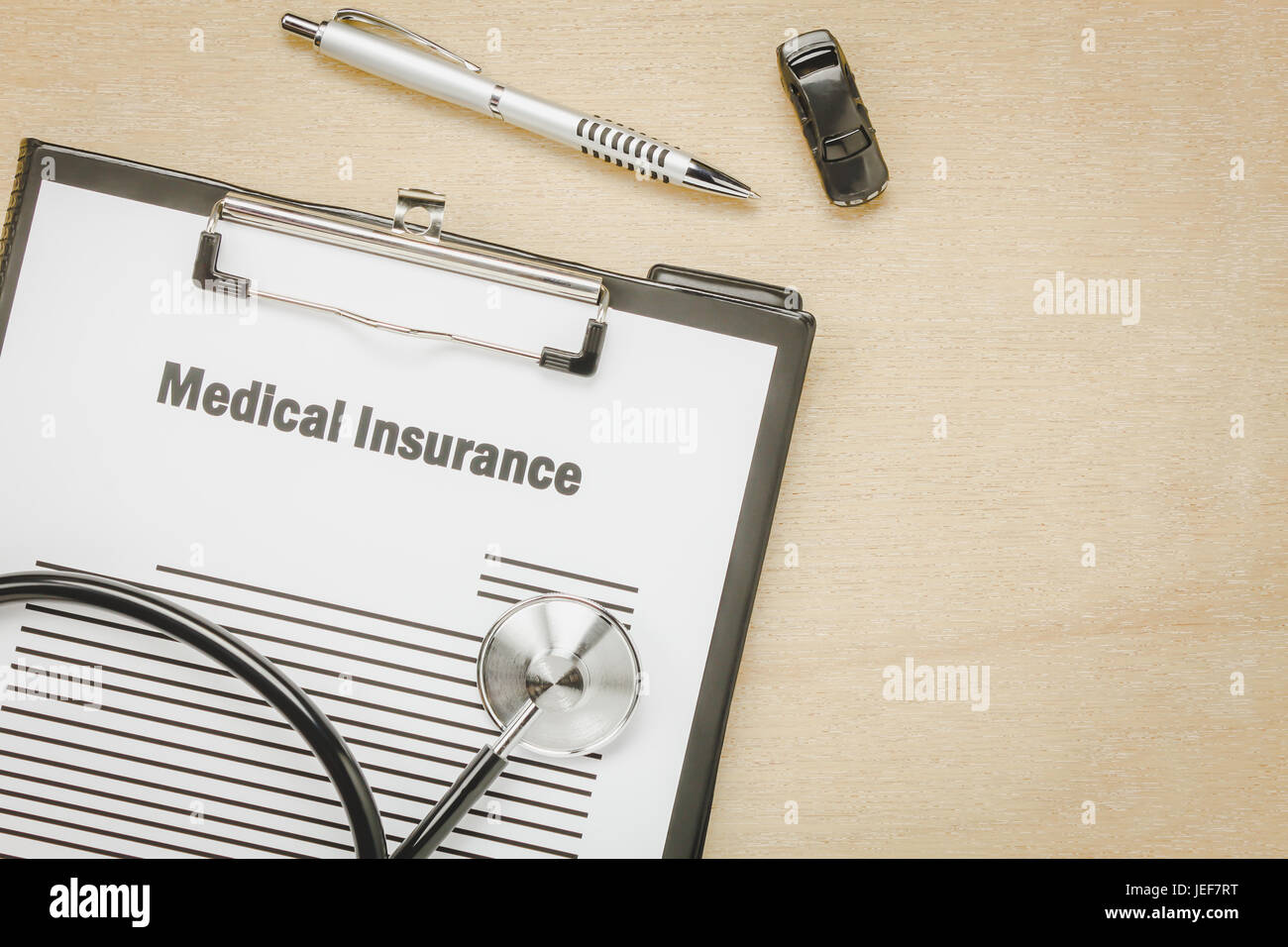 Top view medical insurance form with stethoscope,car on wooden ...