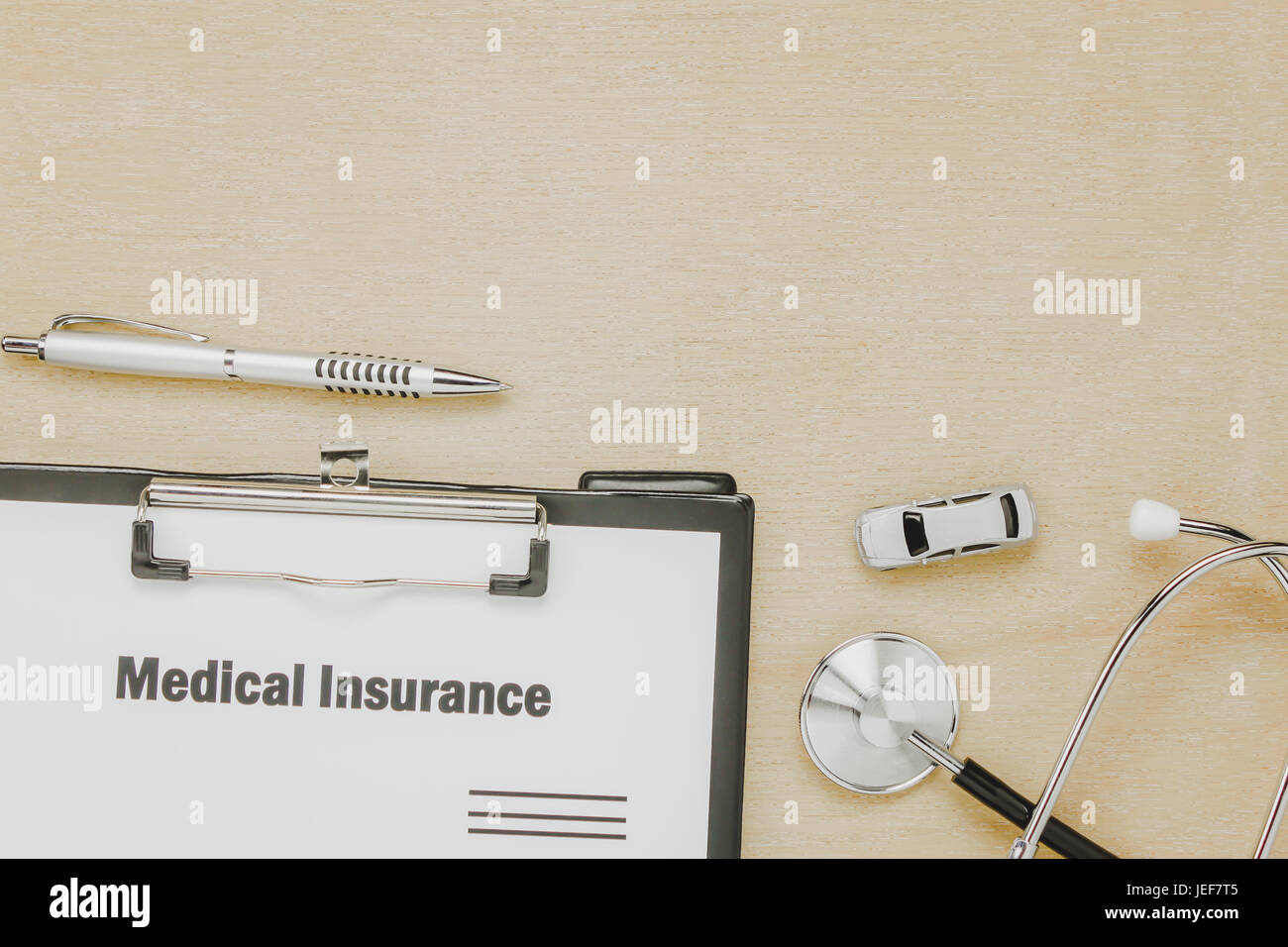 Top view medical insurance form with stethoscope,car on wooden ...