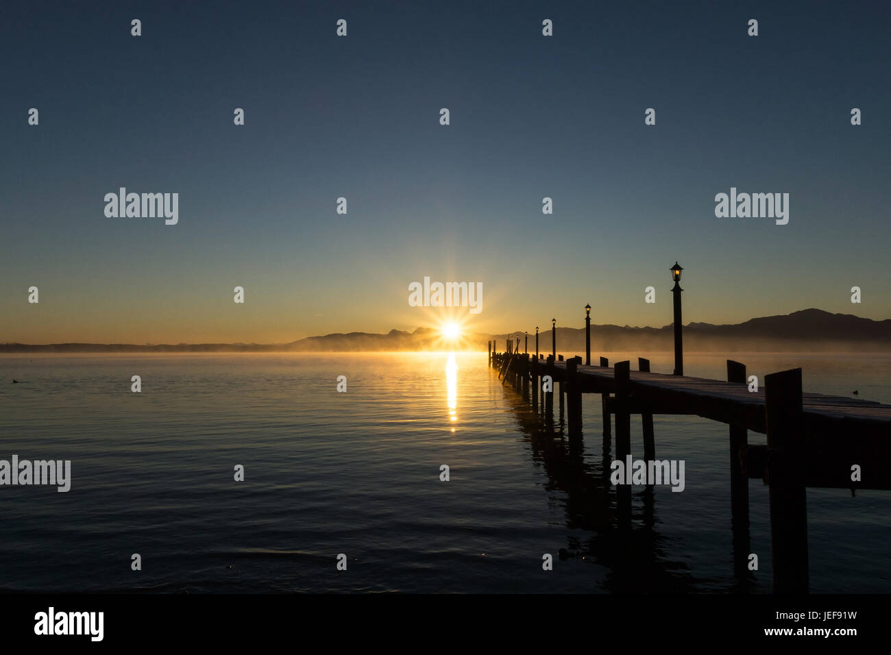 Accepted in Lake Chiem in Bavaria, Germany, in January. Footbridge in ...
