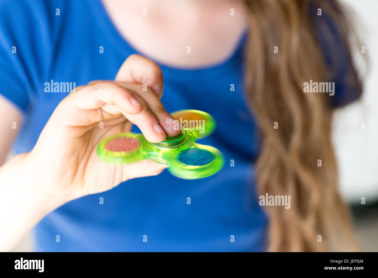 Child playing with fidget spinner hi-res stock photography and images ...