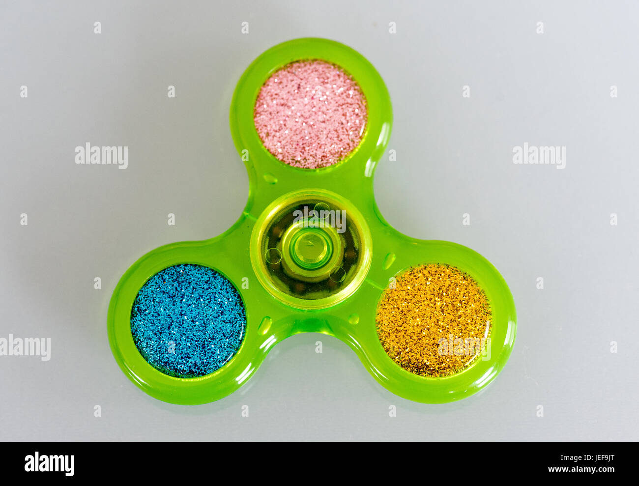 Green fidget spinner stress relieving toy on white background Stock ...